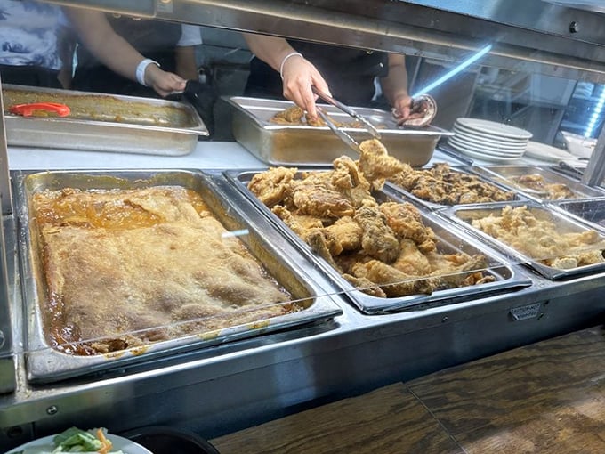 Steam table treasures await as golden-fried chicken gets the VIP treatment it deserves – crispy on the outside, juicy salvation within.