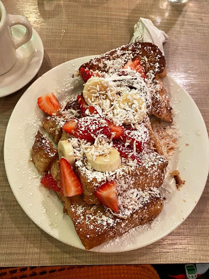 French toast that makes ordinary bread feel inadequate. Those fresh strawberries and bananas are trying to make this indulgence seem healthy—don't be fooled.