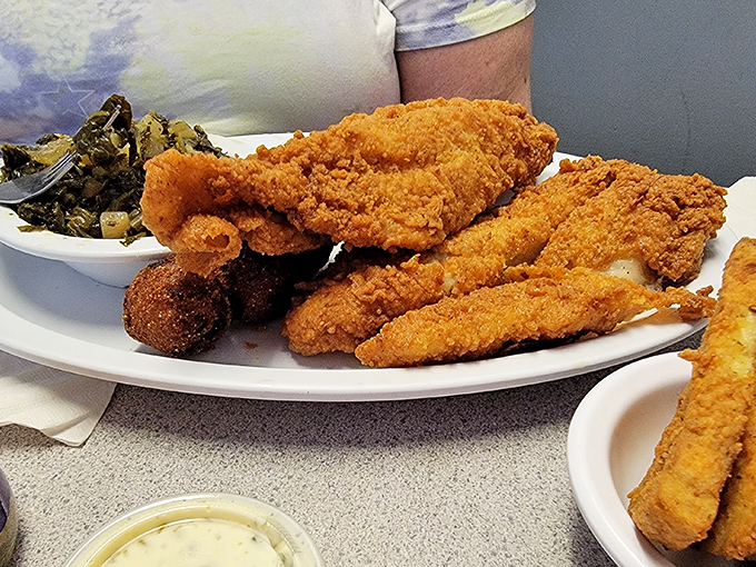 Golden-fried catfish that shatters with each bite, revealing flaky white flesh within—proof that simple food done right is culinary poetry.