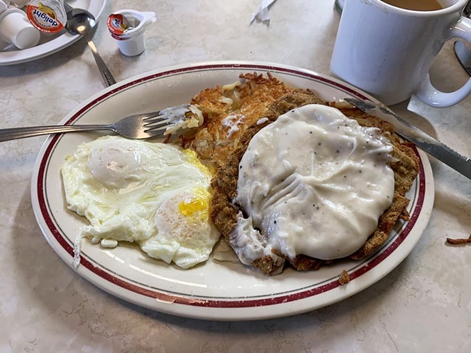 Country fried steak with gravy and eggs—the breakfast equivalent of a warm hug from someone who really means it.
