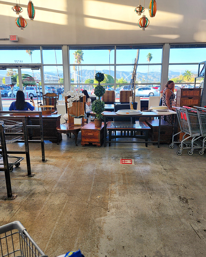 The furniture showroom offers a glimpse of California mountains through the windows, while inside, dining sets await their next family gathering.