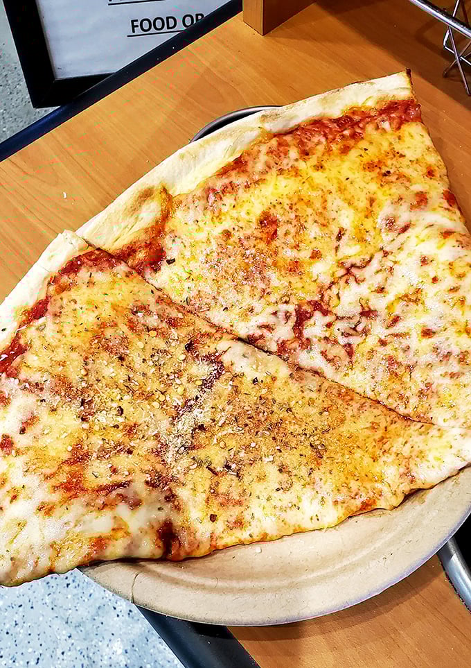 When your pizza slice is bigger than your face, you know you're in the right place. Fold it New York-style or tackle it with utensils—no judgment here.