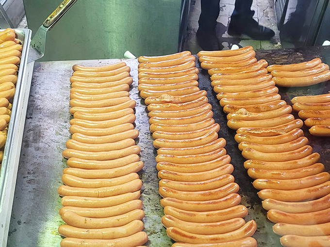 Hot dogs lined up like soldiers awaiting their delicious destiny. There's something hypnotically beautiful about this level of hot dog commitment.