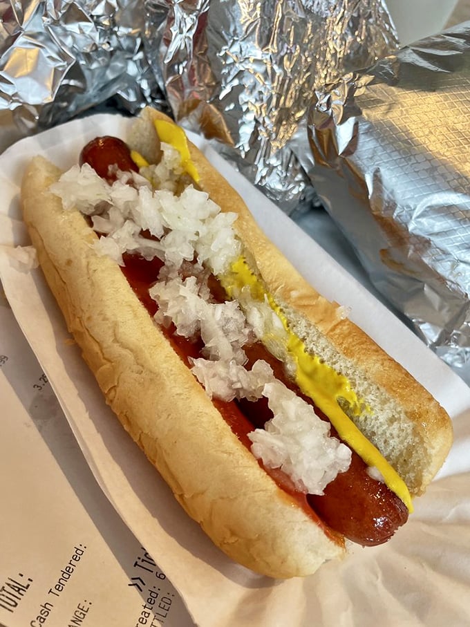 The hot dog comes dressed for success with mustard, onions, and a soft bun that cradles the snap of that first perfect bite.