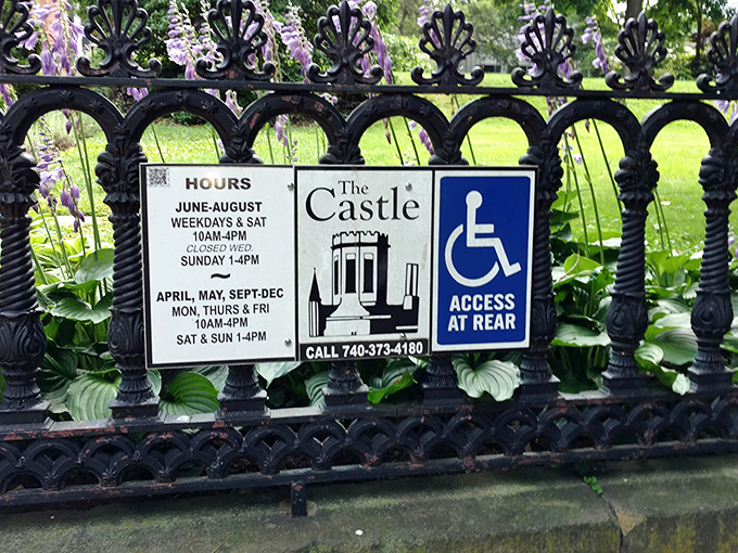 The ornate iron fence doesn't just mark boundaries—it announces to passersby: "Yes, there's actually a castle in Marietta, and yes, you can visit."