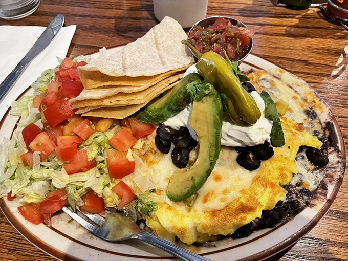Huevos Rancheros that would make your abuela proud – a fiesta of flavors topped with fresh avocado and sour cream.