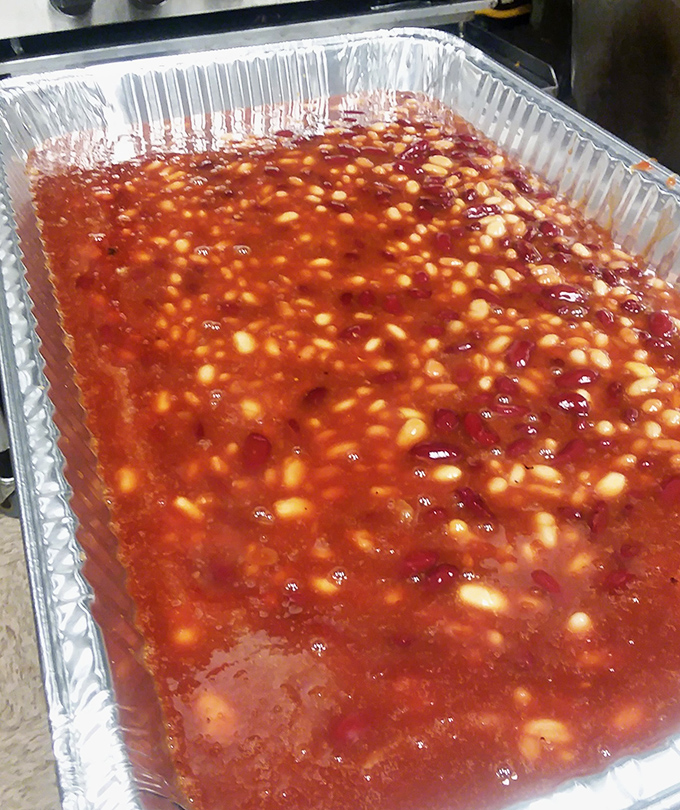 These baked beans have clearly been introduced to their meaty neighbors in the smoker—a sweet and savory symphony in every spoonful.