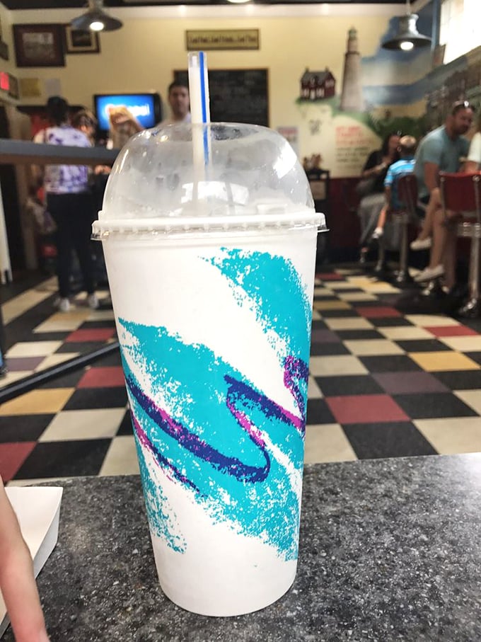 The blue swirl in this frozen creation isn't just for show—it's visual jazz for a drink that tastes like summer vacation in a cup.