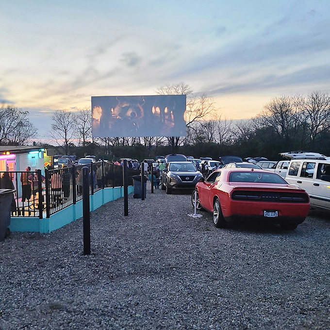 As dusk settles, the massive screen flickers to life, turning windshields into personal theater boxes under an open sky. 