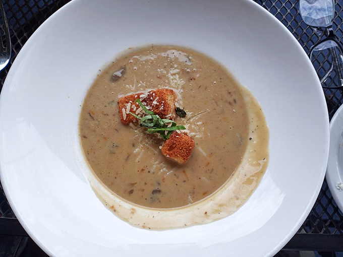 This mushroom soup isn't just a starter—it's liquid comfort in a bowl, topped with a crouton island that deserves its own real estate listing.