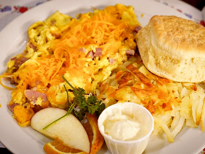 This omelet doesn't just have cheese—it wears it like a proud yellow crown. Hash browns crispy enough to make a potato weep with joy.