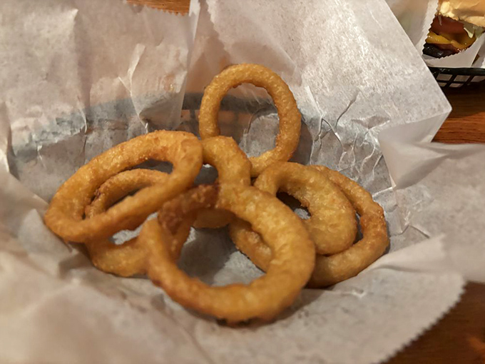 Golden rings of crispy perfection. These aren't just onion rings—they're edible halos that make you question why anyone would ever choose regular fries.