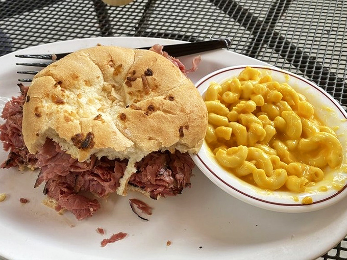 A pastrami sandwich so generous it requires a strategy to eat. The mac and cheese alongside isn't just comfort food—it's emotional support in a bowl.
