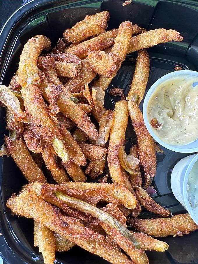 Pickle fries—the side dish you didn't know you needed in your life. Tangy, crunchy strips of happiness with dipping sauce for good measure.