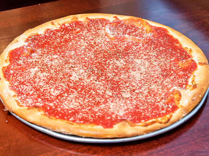 The tomato pie speaks the universal language of simplicity—a thin crust canvas painted with vibrant sauce and a dusting of cheese that whispers rather than shouts.