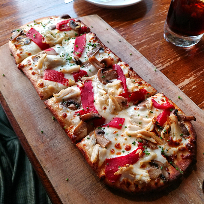 Pizza that defies categorization—thin crust, melty cheese, and toppings arranged with artistic precision. The kind worth driving across state lines for.
