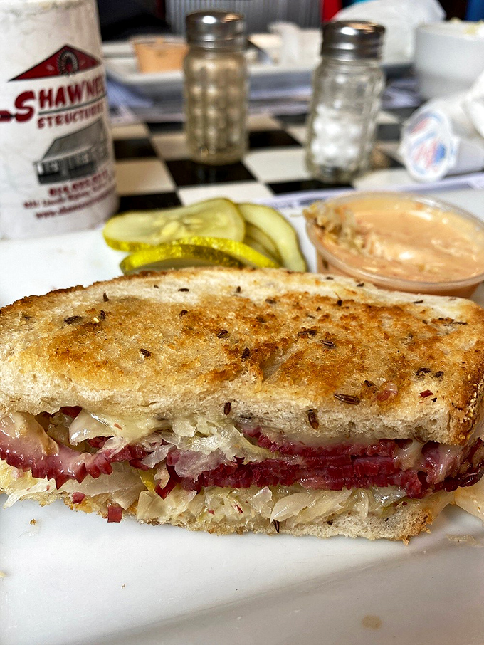 The Reuben sandwich – where sauerkraut, corned beef, and Swiss cheese perform a perfect harmony that would make the Carnegie Deli proud.