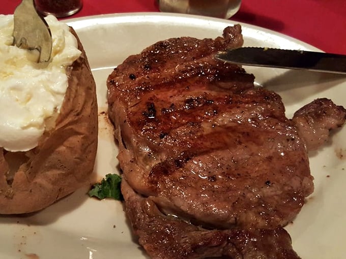 A ribeye with the kind of char that makes you want to write poetry, paired with a potato that's having its own moment of glory.