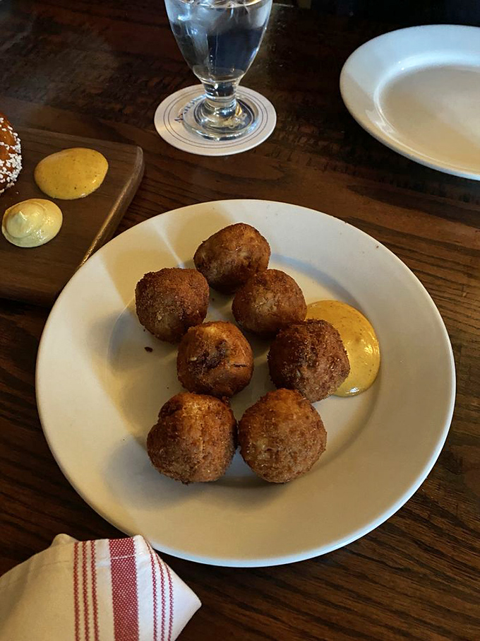 The legendary sauerkraut balls in their natural habitat—golden-brown spheres of joy served with house-made mustard that'll haunt your dreams.