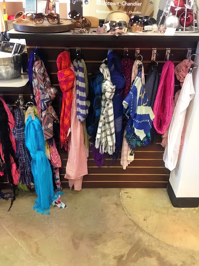 A rainbow of scarves waiting to transform basic outfits into "I have a personal stylist" territory – affordable neck real estate.