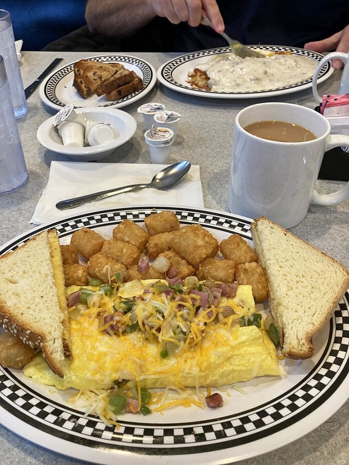 An omelet that's seen things—namely ham, cheese, and vegetables—all tucked under a comforting blanket of melted goodness.