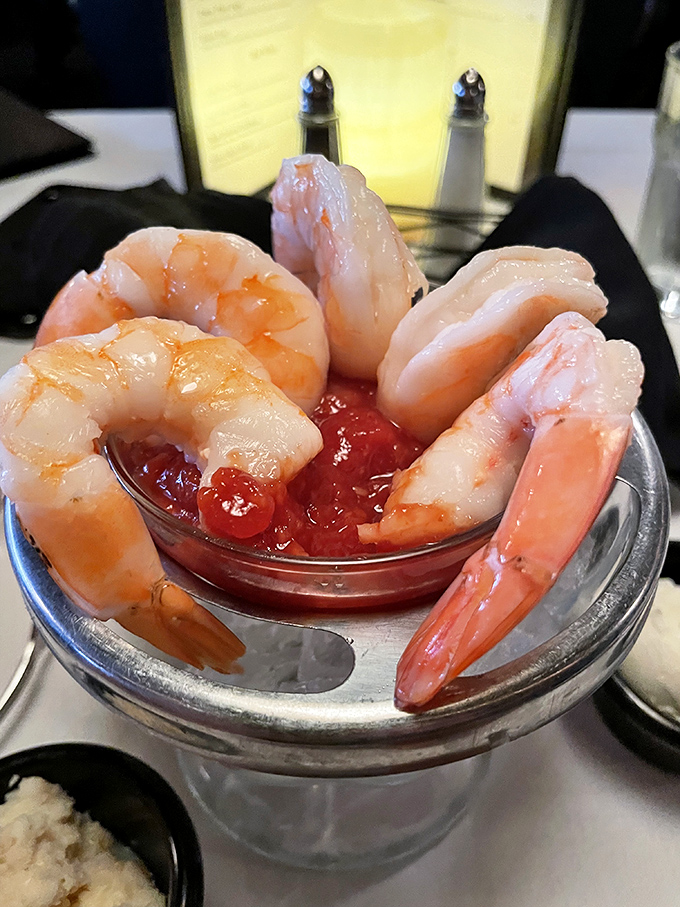 The shrimp cocktail – where each crustacean curves around the dish like synchronized swimmers performing in a pool of zesty cocktail sauce.