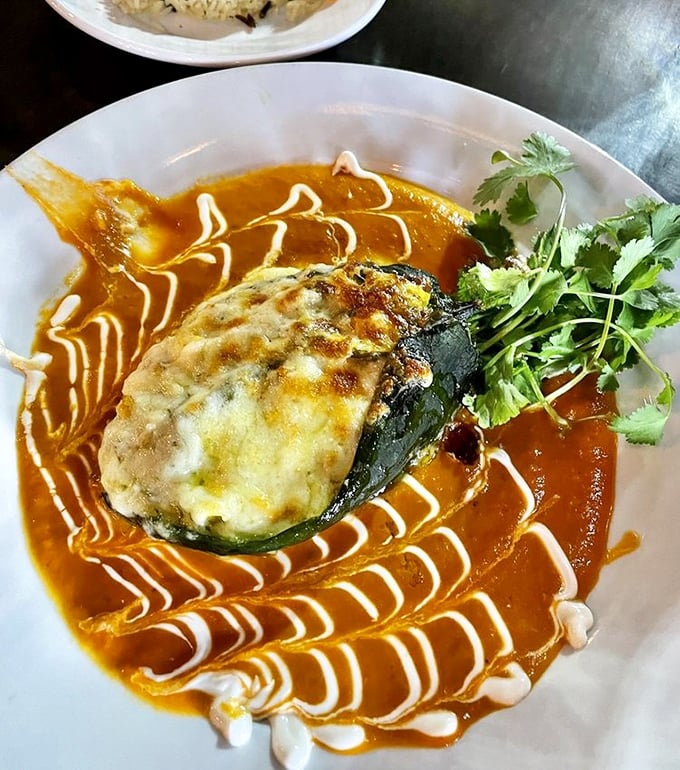 This chile relleno with artistic sauce swirls is Mexican cuisine as performance art—the Jackson Pollock of dinner plates.