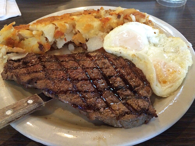 The classic steak and eggs combo: a perfectly grilled piece of beef alongside golden hash browns and sunny eggs—breakfast of champions, lunch of legends.