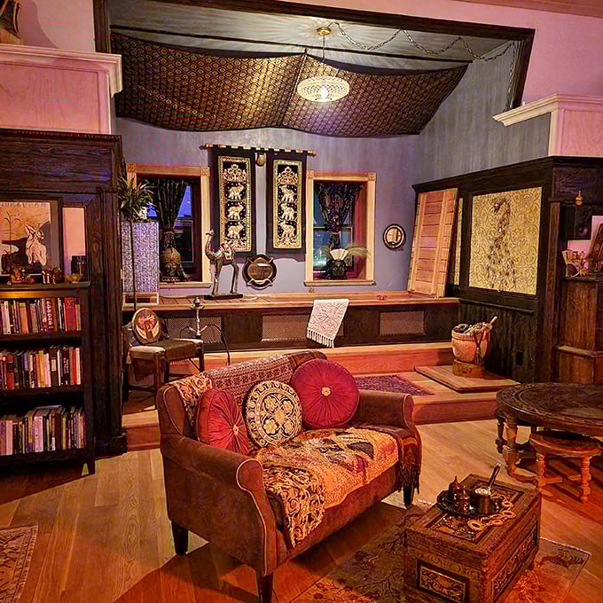 This cozy reading corner with its fabric-draped ceiling feels like stepping into a Moroccan-inspired dream sequence from a Wes Anderson film.