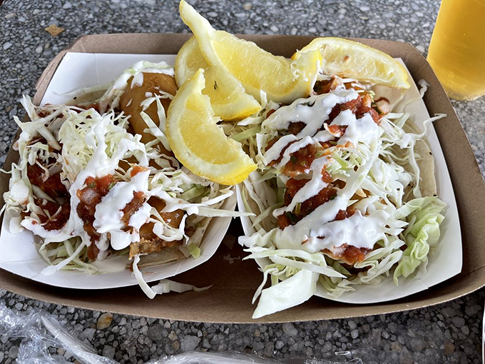 Fish tacos done right – crispy, flaky fish nestled under fresh cabbage with a drizzle of sauce that ties everything together in tortilla harmony.
