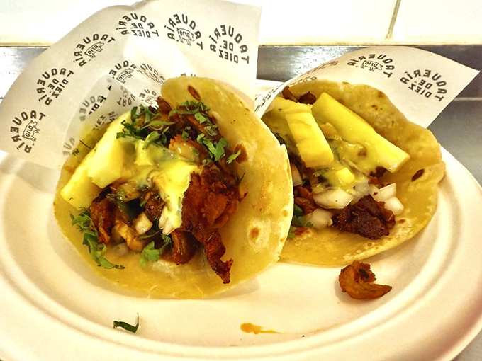 Al pastor tacos with pineapple chunks—proof that sometimes the perfect relationship is just meat, tortilla, and a little tropical sweetness.
