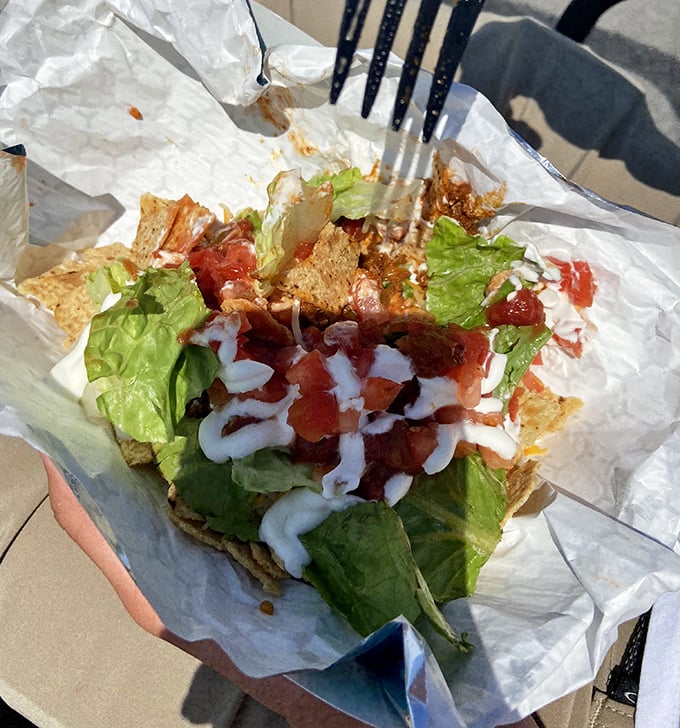 Fresh ingredients transform a simple taco salad into an island fiesta—crisp lettuce, diced tomatoes, and drizzles of sauce creating edible vacation memories.