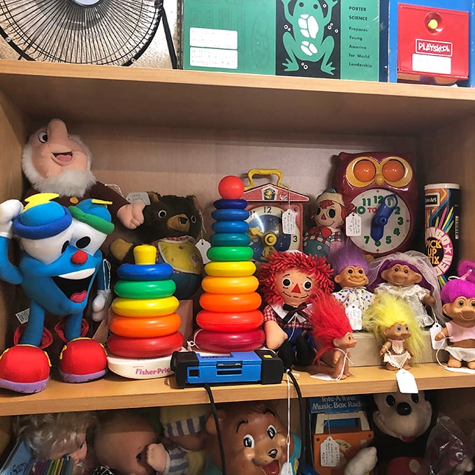 A shelf of childhood memories awaits adoption. That Fisher-Price stacking ring probably taught motor skills to kids who now have grandchildren of their own.
