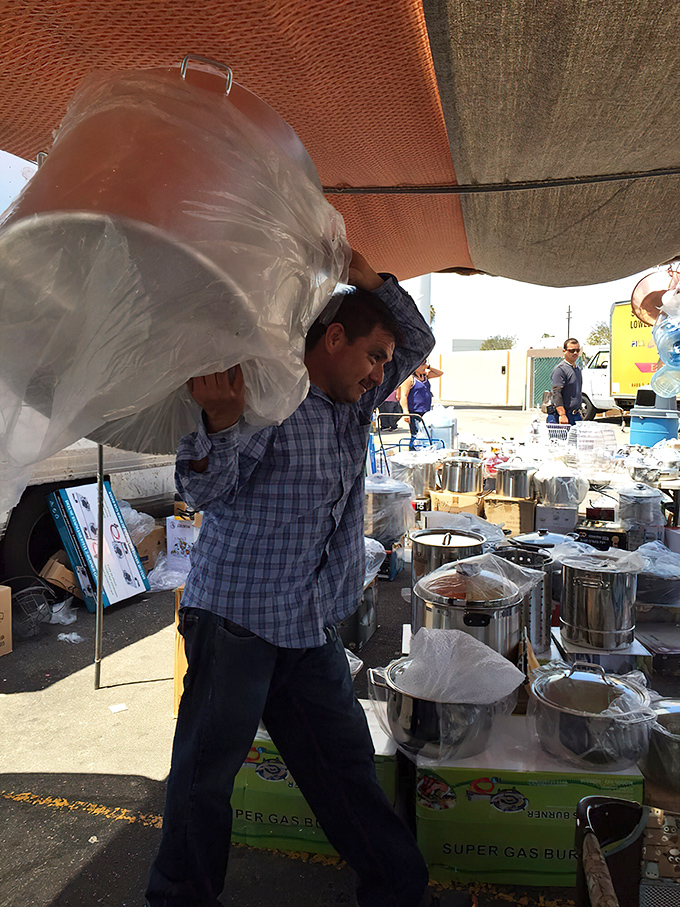 The kitchenware maestro in action! Moving massive cookware with the grace of a conductor leading a symphony of stainless steel.