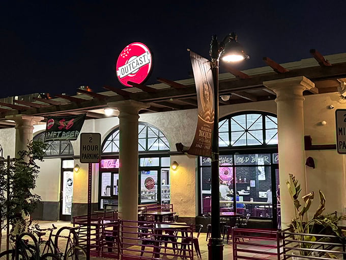Outcast Doughnuts after dark – where night owls and sweet tooths unite under the glow of that perfect pink sign.