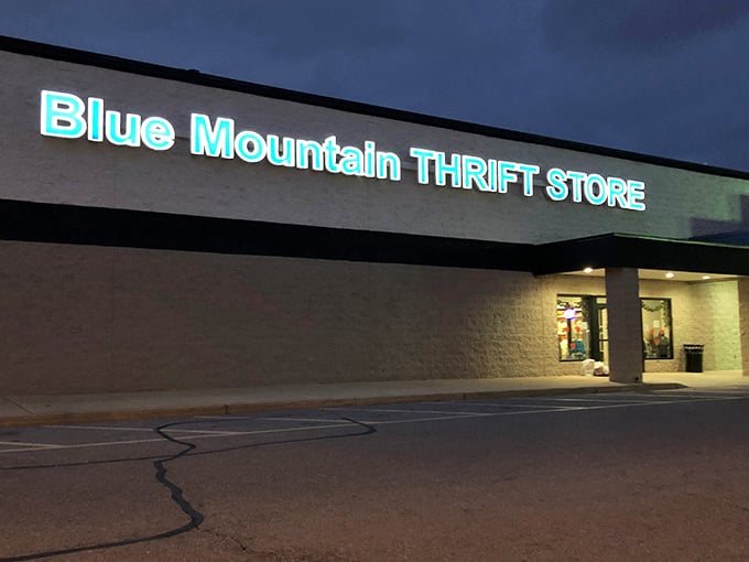 Even after sunset, Blue Mountain's glowing sign guides night owls to last-minute treasures before closing time.