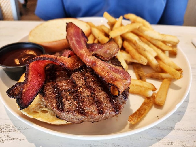 This isn't just a burger – it's a monument to indulgence with bacon standing proud like flags claiming delicious territory.