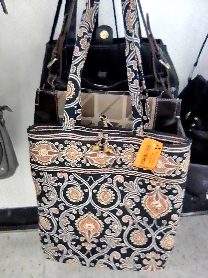 Embroidered elegance waits its turn on the accessory rack, this ornate tote bag whispering tales of dinner parties past and brunches yet to come.