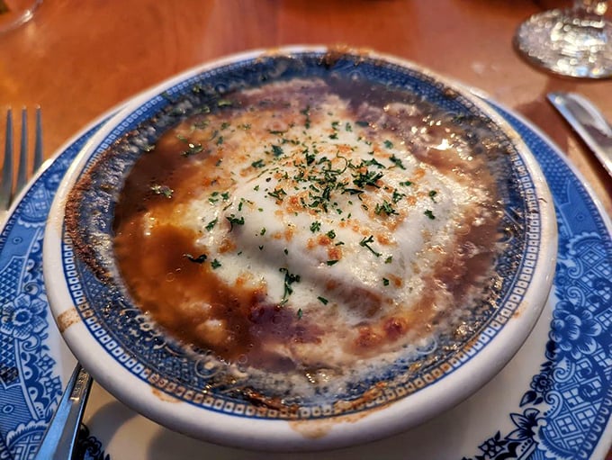 This onion soup isn't playing games – it's a serious commitment to cheese, broth, and happiness that would make a French chef nod respectfully.