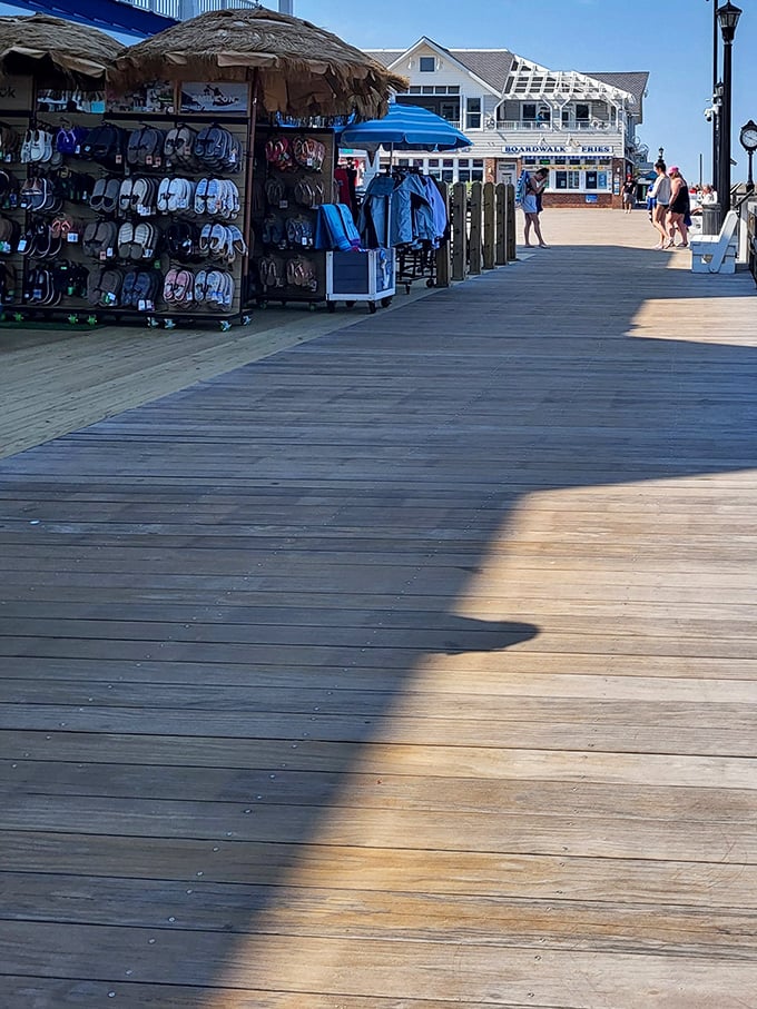Beach essentials on display—flip-flops hanging like tropical fruit, ready to be plucked by barefoot visitors seeking relief from hot boardwalk planks.