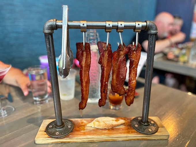 Bacon elevated to performance art. This isn't just breakfast's sidekick anymore—it's the main event, hanging like delicious curtains on an industrial stage.