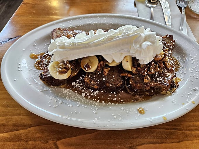 Bread pudding that makes you question why anyone bothers with other desserts. Those bananas and whipped cream aren't just toppings—they're co-stars.