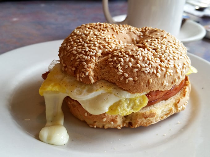 Breakfast sandwich architecture at its finest—the melty cheese dripping just so, the sesame bagel providing the perfect foundation.