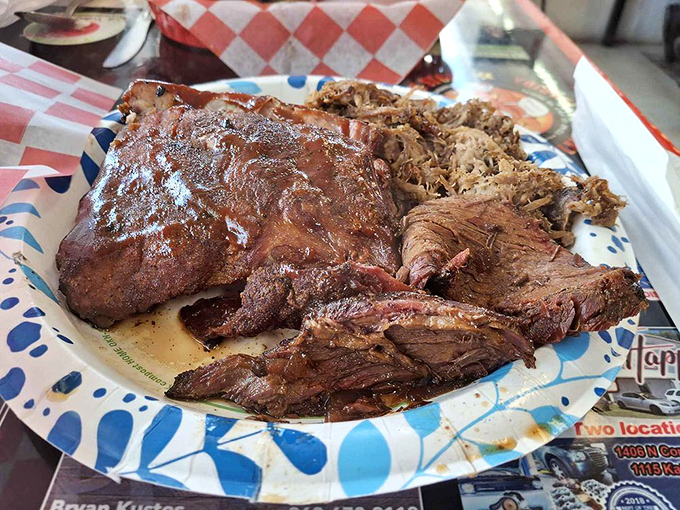 The carnivore's dream team: brisket, ribs, and pulled pork sharing a plate like old friends at a reunion. This isn't just BBQ—it's edible artwork. 