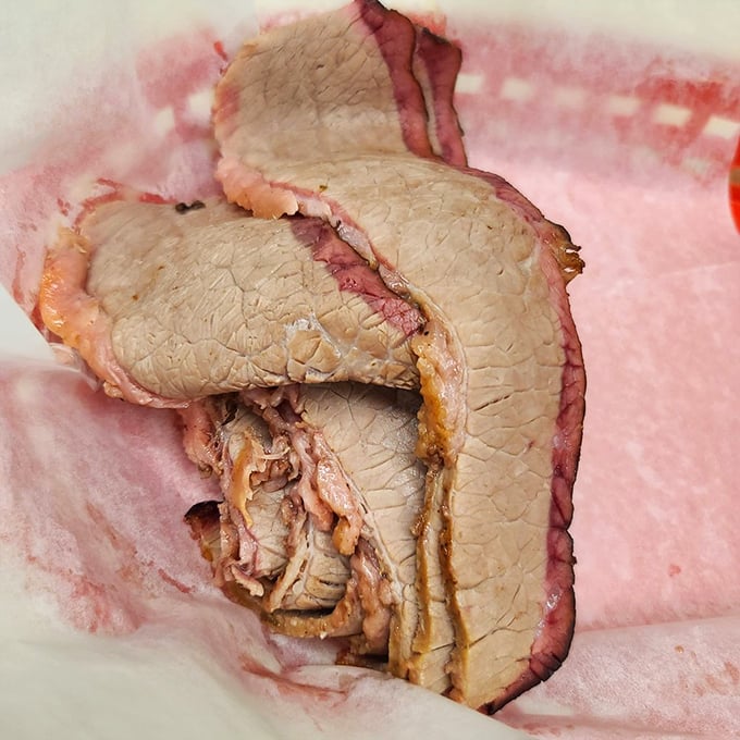 Sliced brisket with that telltale pink smoke ring—evidence of patience, skill, and the transformative power of slow cooking. 