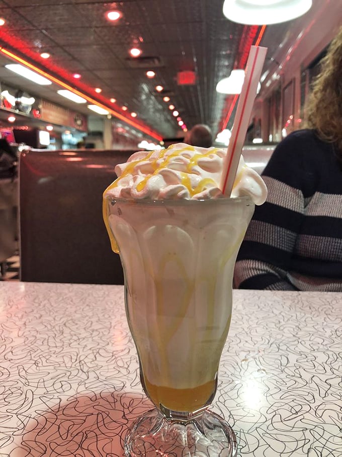 This isn't just a milkshake—it's a butterscotch masterpiece topped with whipped cream that requires both a straw and spoon commitment.