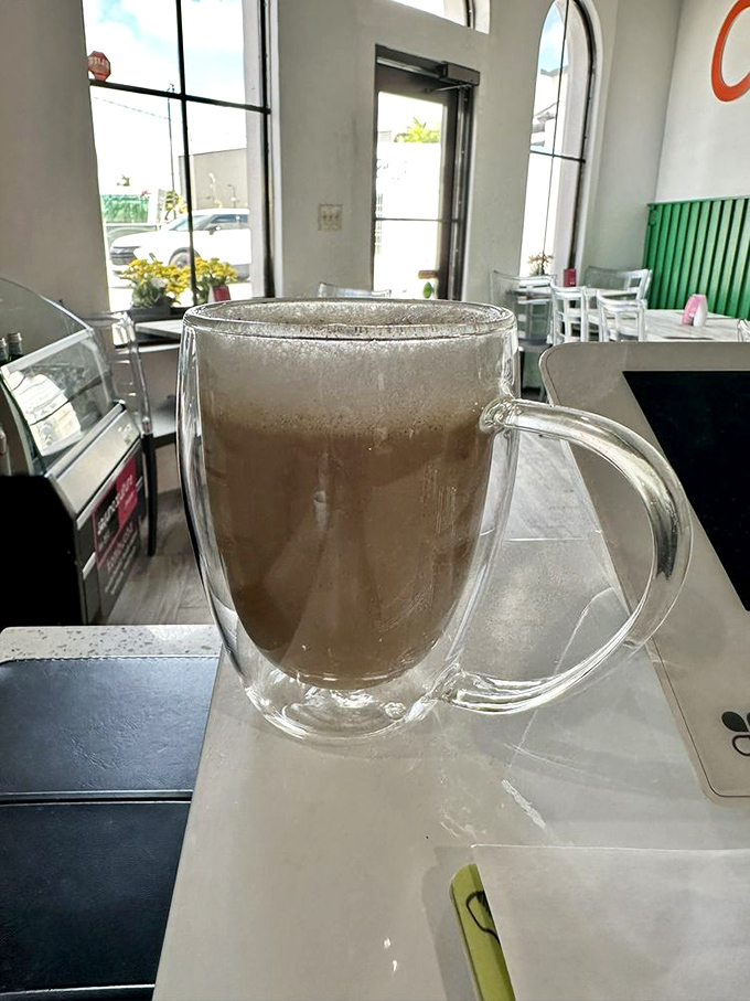 That's not just a cappuccino—it's liquid therapy in a double-walled glass, perfect for contemplating life's big questions, like "Should I order seconds?"