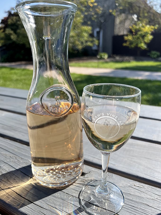 A carafe of crisp white wine catching the sunlight—nature's way of saying "it's definitely wine o'clock somewhere."