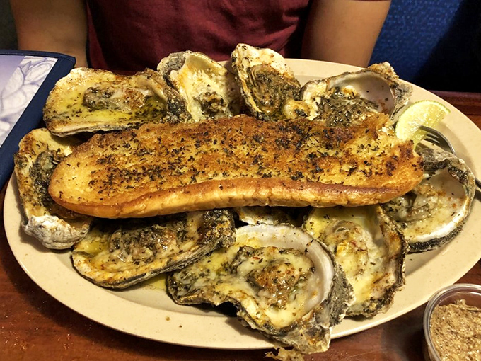 Chargrilled oysters surrounding a fish filet like courtiers around royalty—a seafood arrangement that demands your full attention.