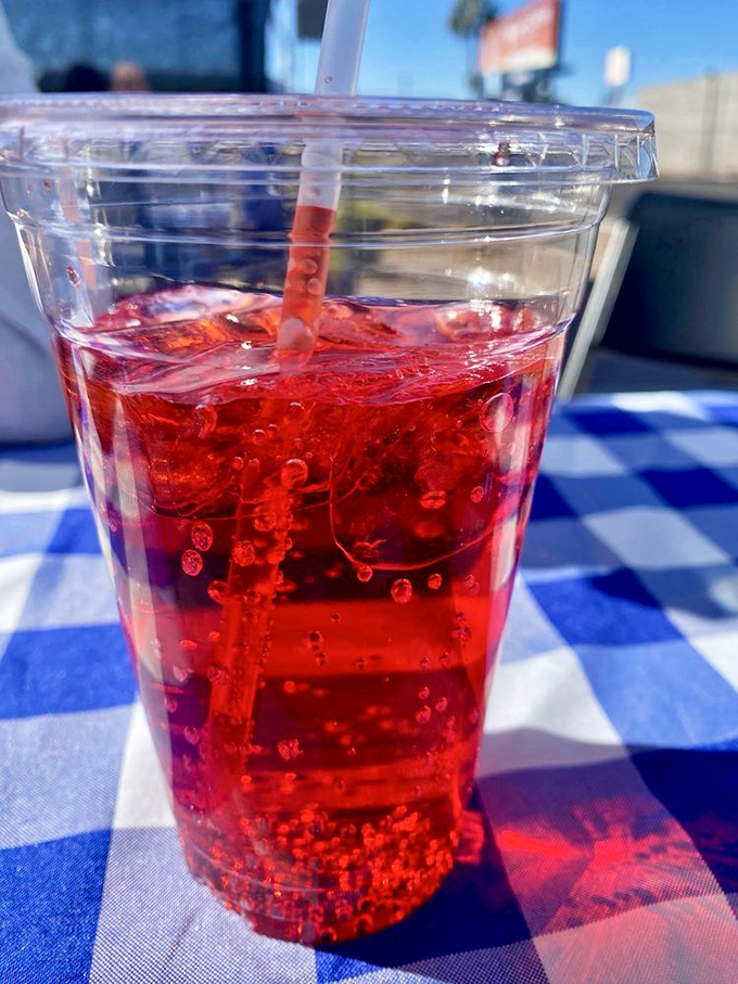 Even the drinks here have personality. This vibrant cherry soda practically glows against the blue-checked tablecloth—a sweet, fizzy palate cleanser.